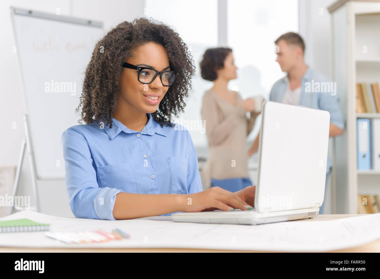 Female employee is working on the laptop Stock Photo - Alamy