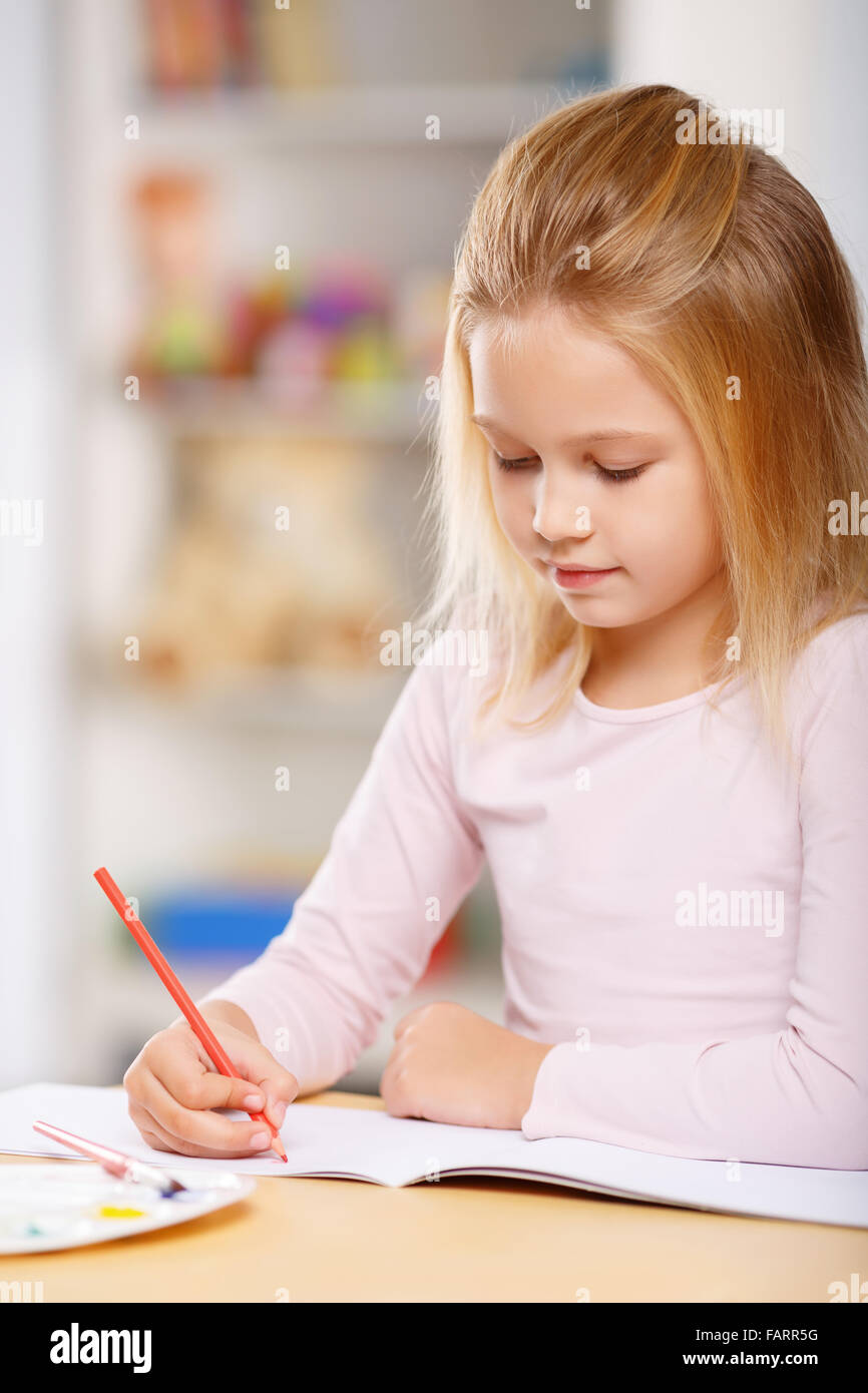 Small child is busy drawing Stock Photo - Alamy