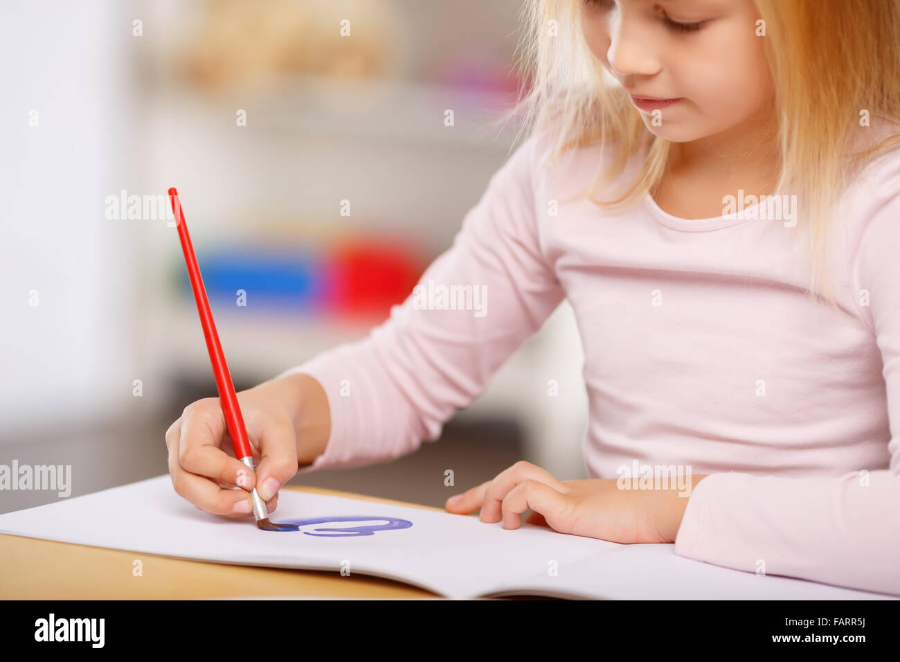 Girl is busy painting with watercolor Stock Photo - Alamy