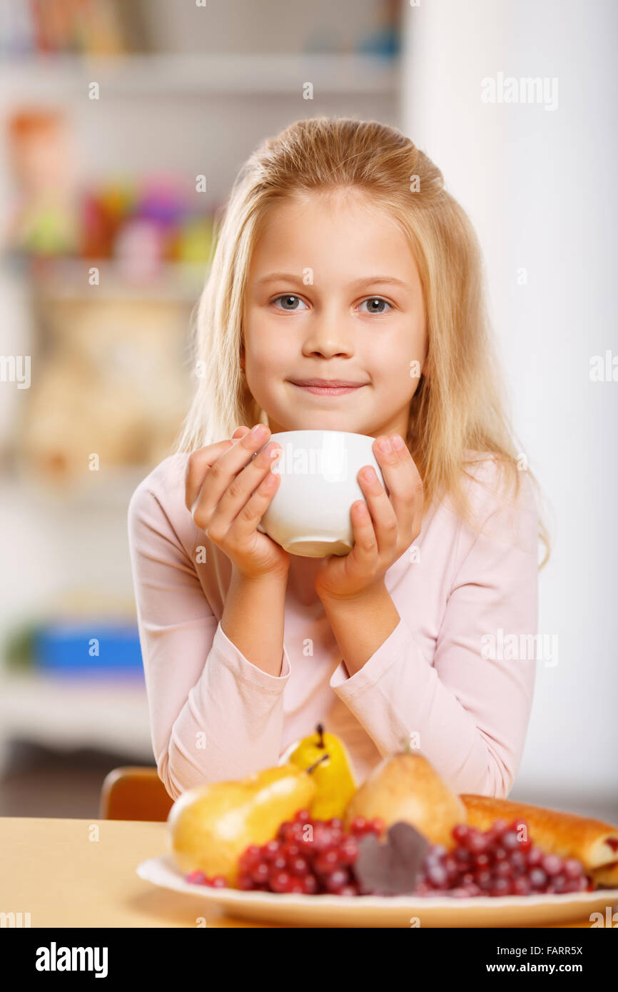 Little girl is drinking tea Stock Photo - Alamy