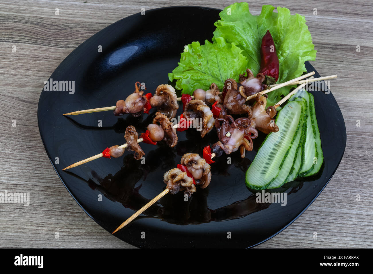 Barbecue baby octopus with bell pepper and spices Stock Photo - Alamy