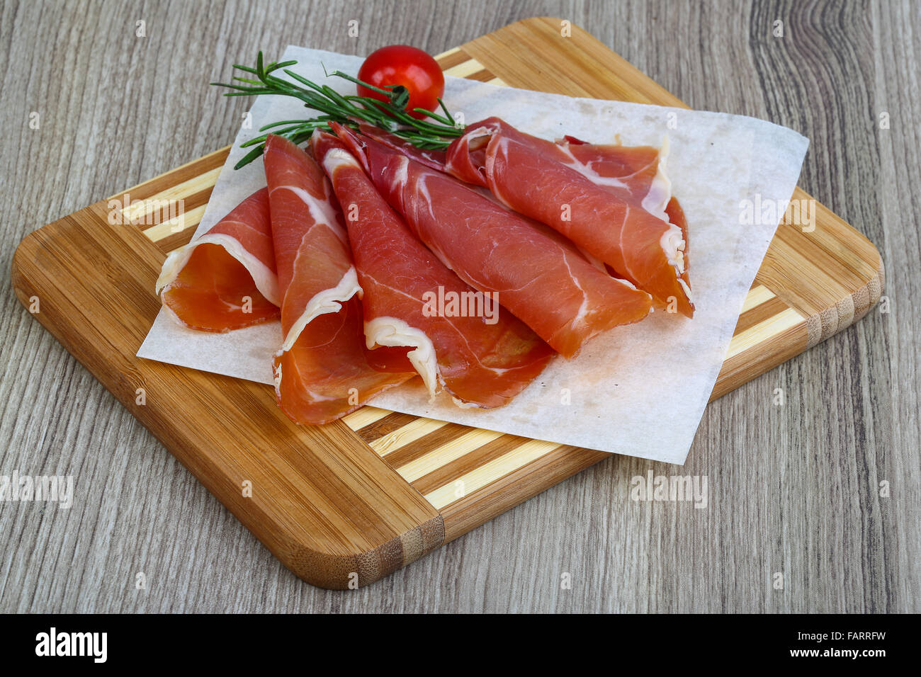 Spanish traditional snack - Jamon with tomato and rosemary Stock Photo ...