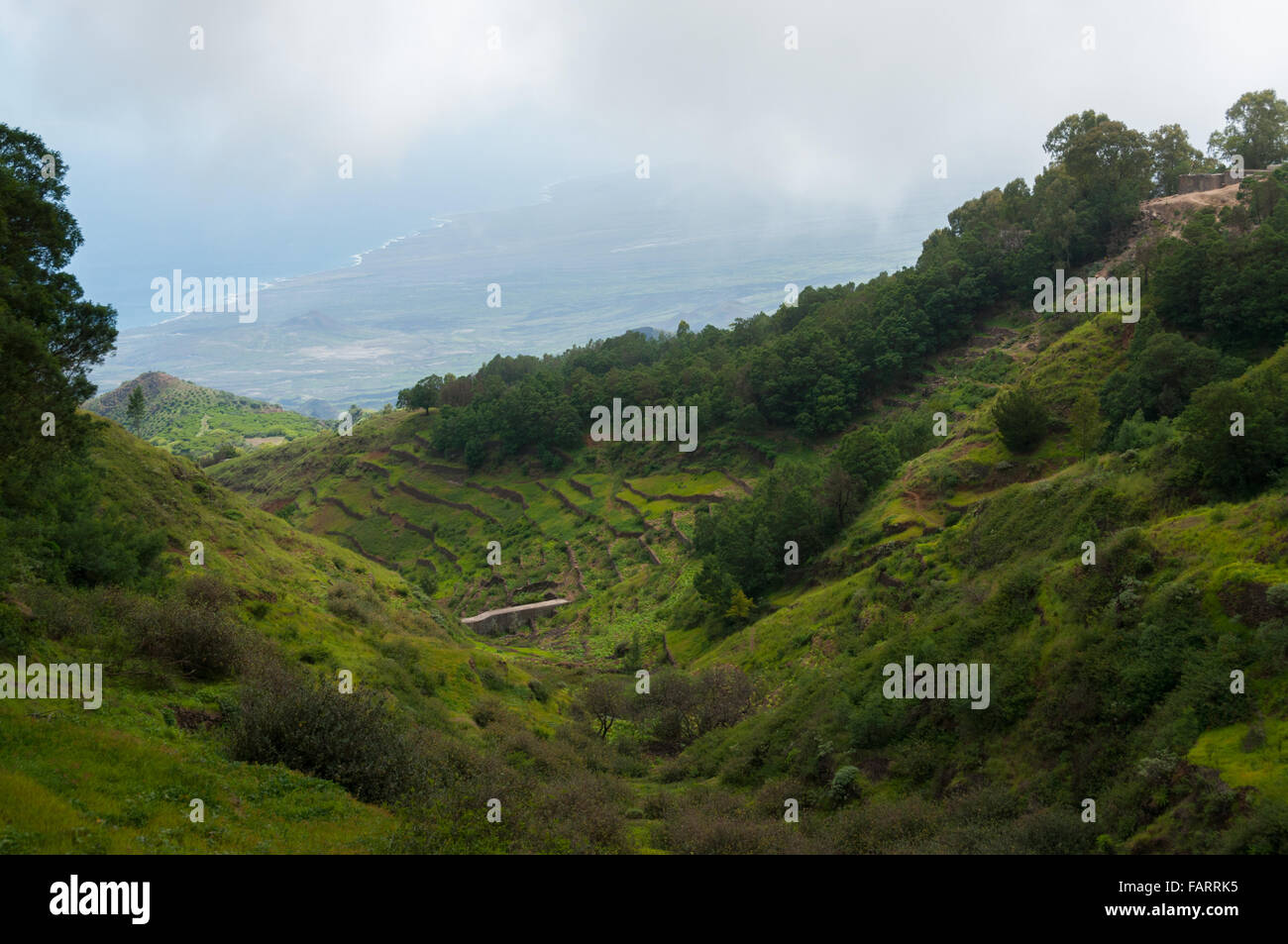 Steep green valley viewpoint leading to blue ocean coast of cape verde ...