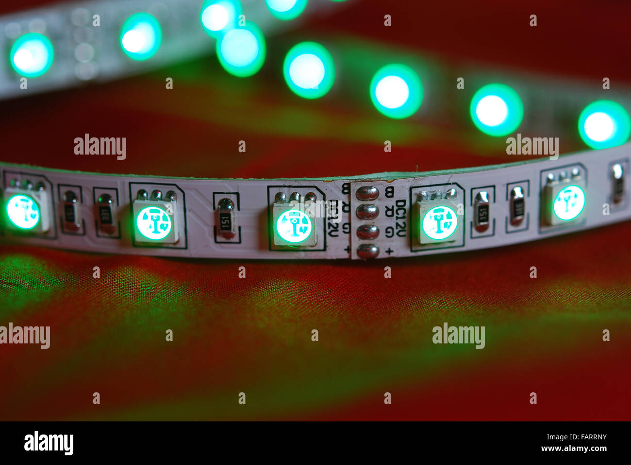 Green led strip on the background of red textile Stock Photo - Alamy