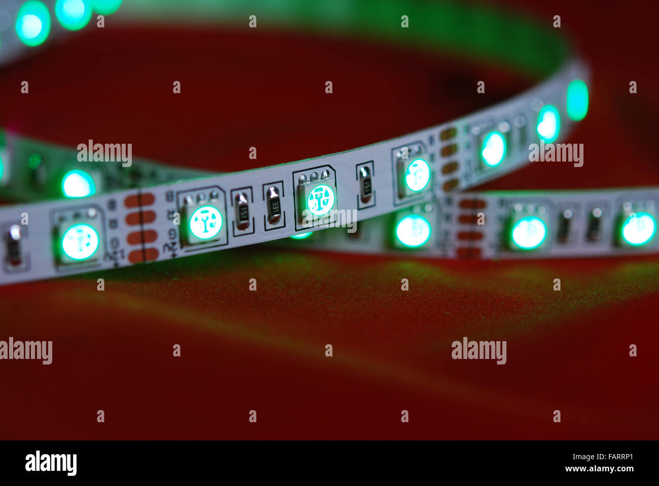 Green led strip on the background of red textile Stock Photo - Alamy