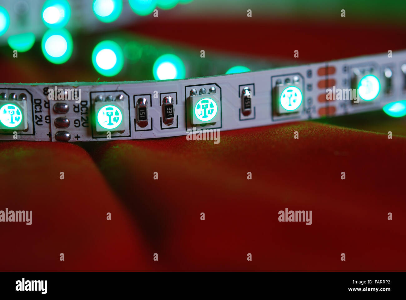 Green led strip on the background of red textile Stock Photo - Alamy