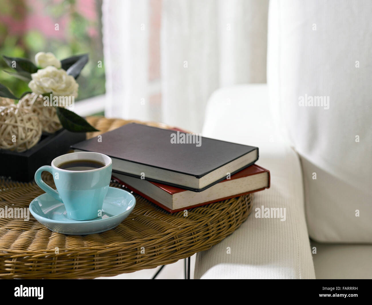 tea cup and books on a table Stock Photo - Alamy
