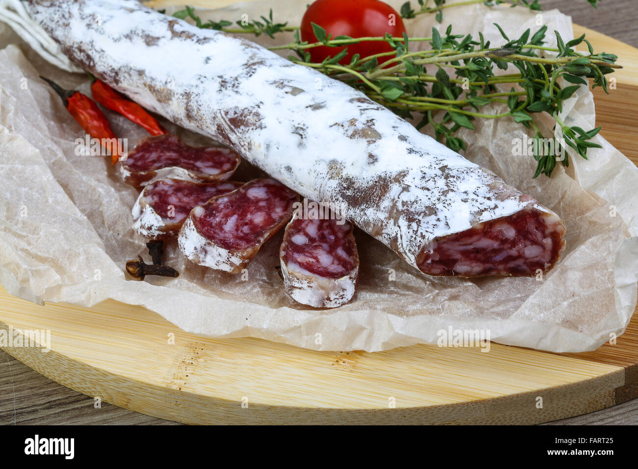 Traditional Spanish sausages- fuet with thyme leaves on the wood ...