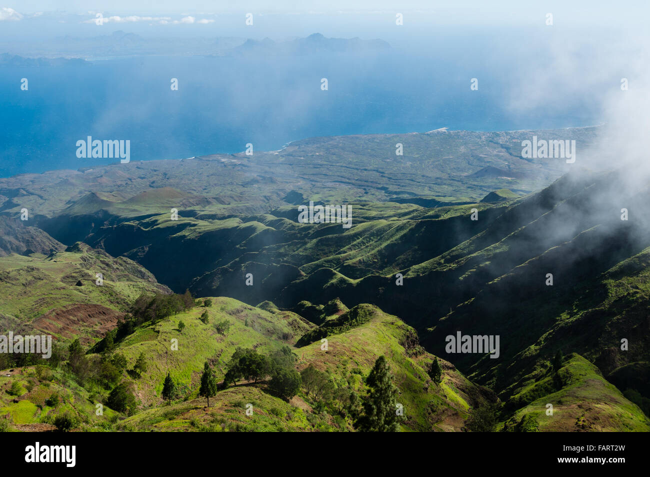 Steep green valley viewpoint leading to blue ocean coast of cape verde ...