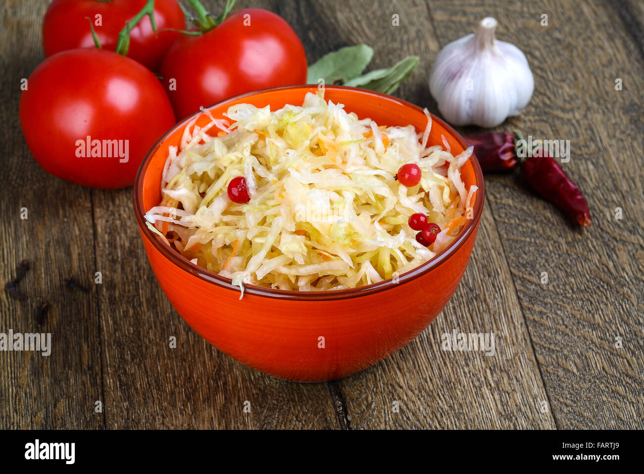 Fermented cabbage - Sauerkraut with herbs and spices on the wood ...