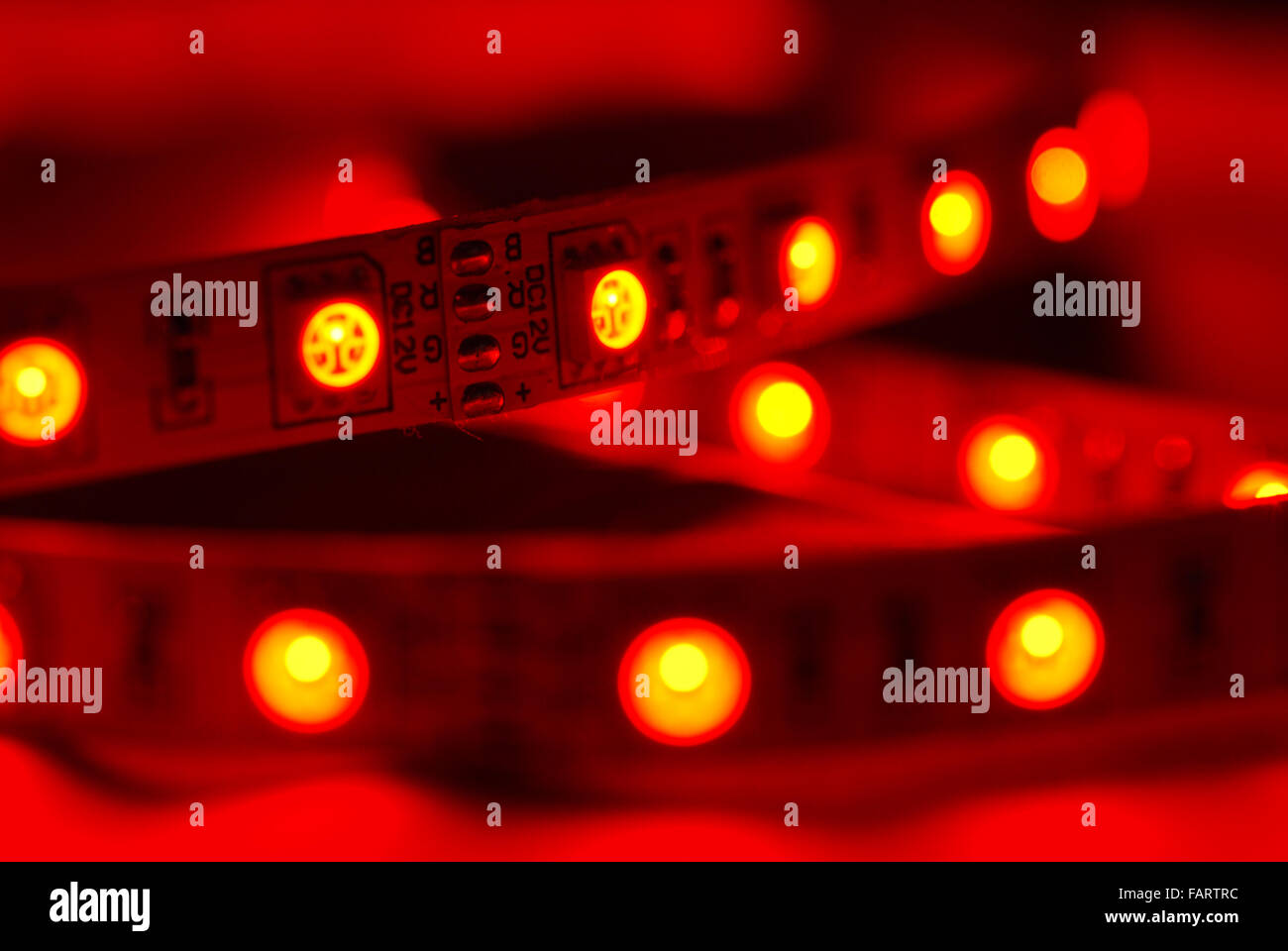 red led strip on the background of red textile Stock Photo - Alamy