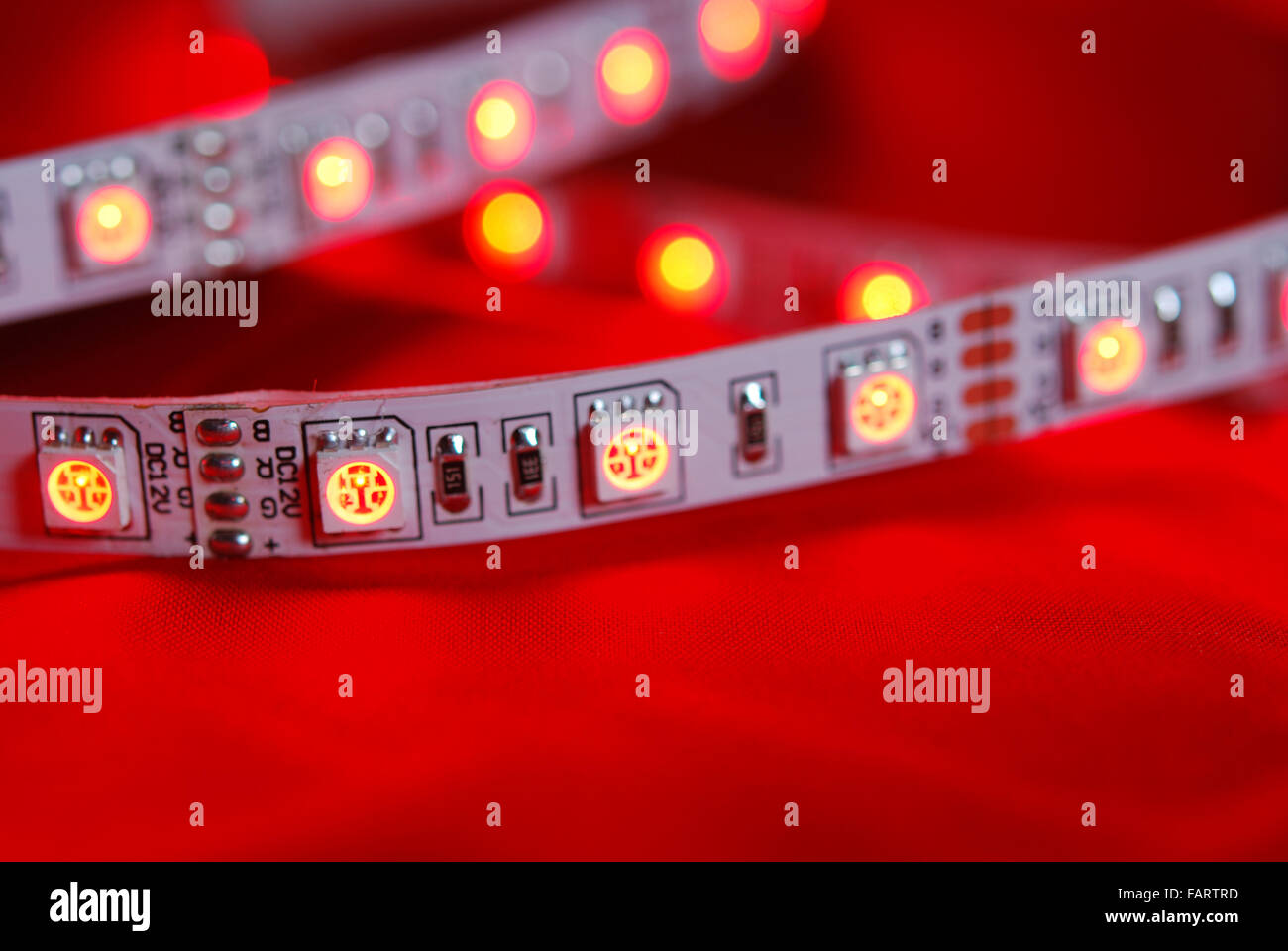 red led strip on the background of red textile Stock Photo - Alamy