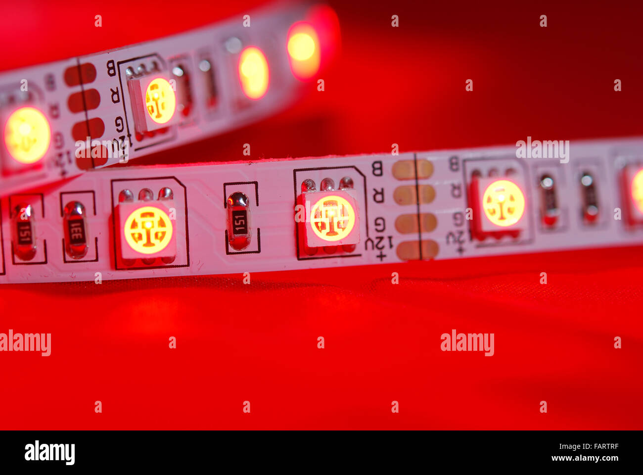 red led strip on the background of red textile Stock Photo - Alamy