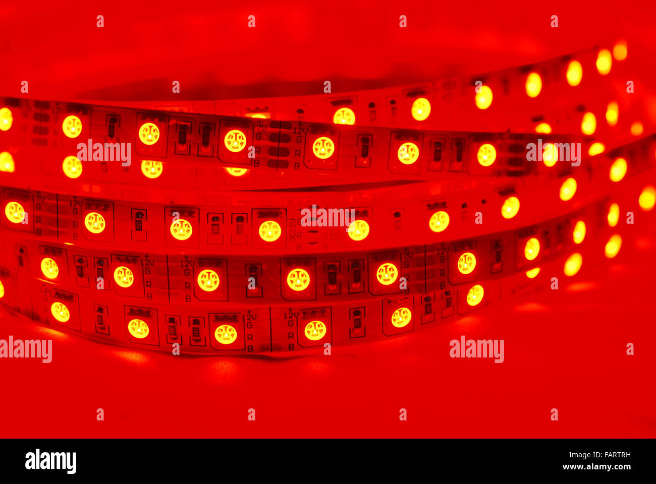 red led strip on the background of red textile Stock Photo - Alamy
