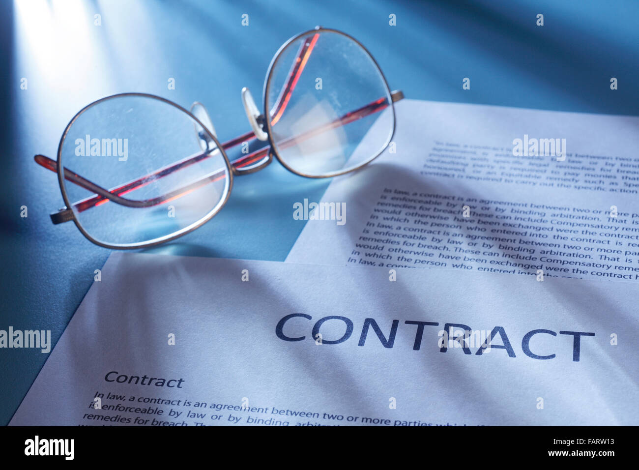 Contract with a pair of glasses Stock Photo - Alamy