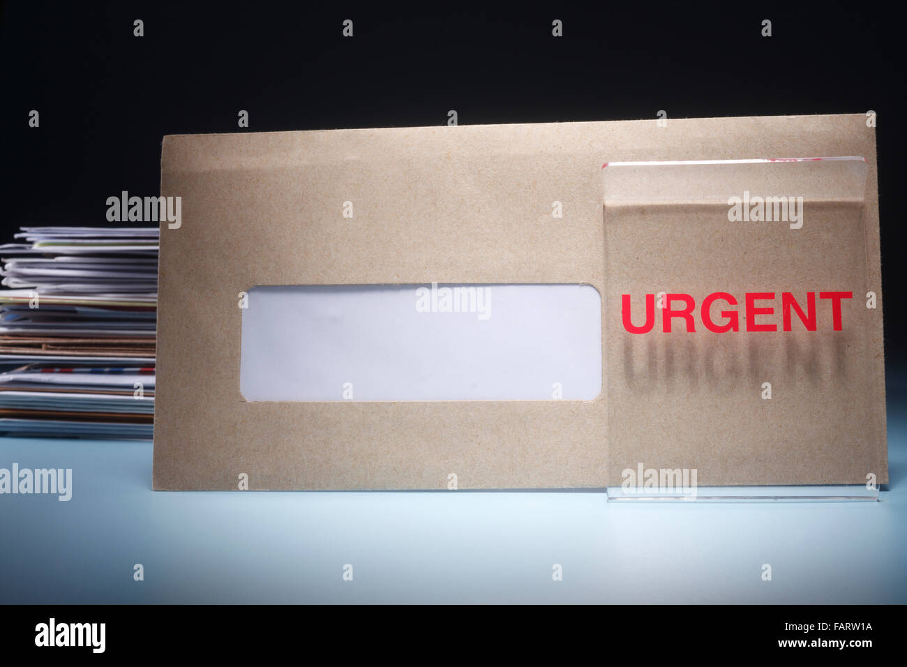 Stack of envelopes with urgent sign Stock Photo - Alamy