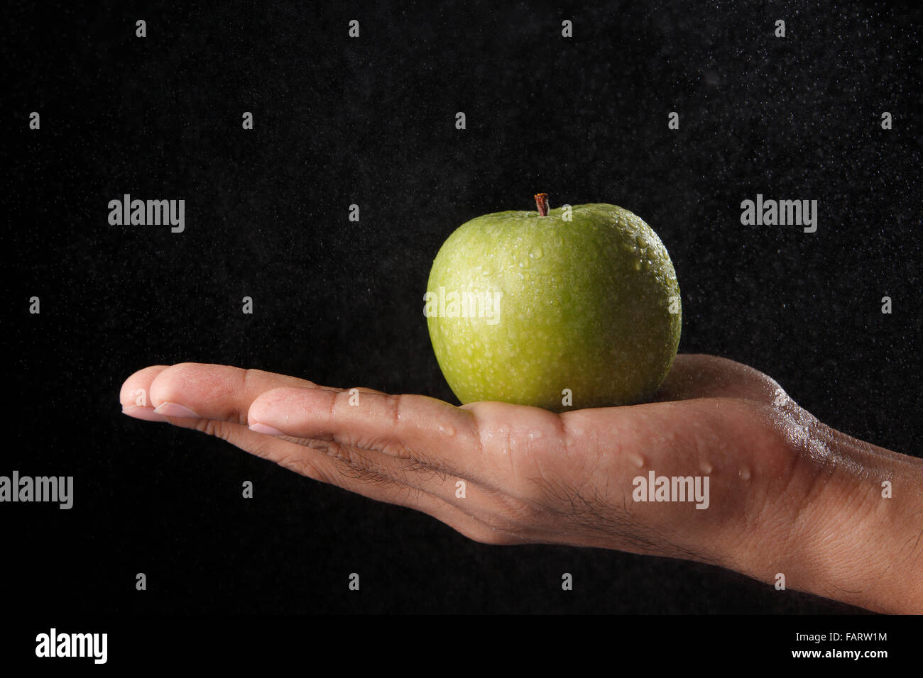Green apple on a palm Stock Photo - Alamy
