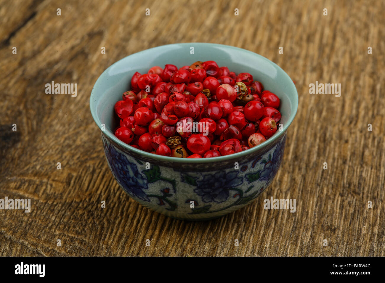 Dry Rose pepper corn on the wood background Stock Photo - Alamy