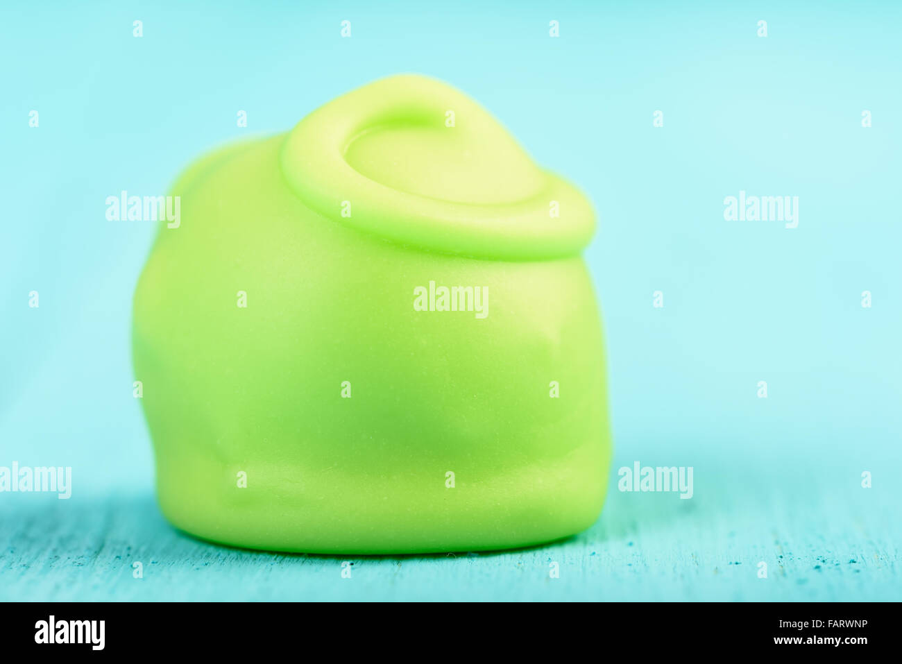 Green Fondant Candy On Turquoise Background Stock Photo - Alamy
