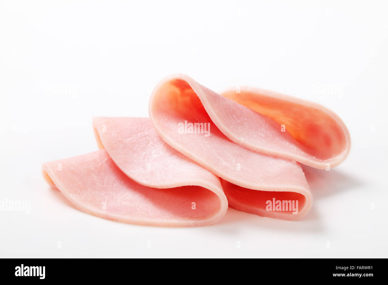 Thin slices of ham on white background Stock Photo - Alamy