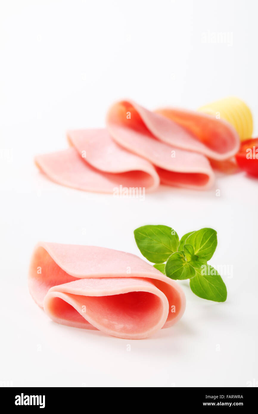 Thin slices of ham on white background Stock Photo - Alamy