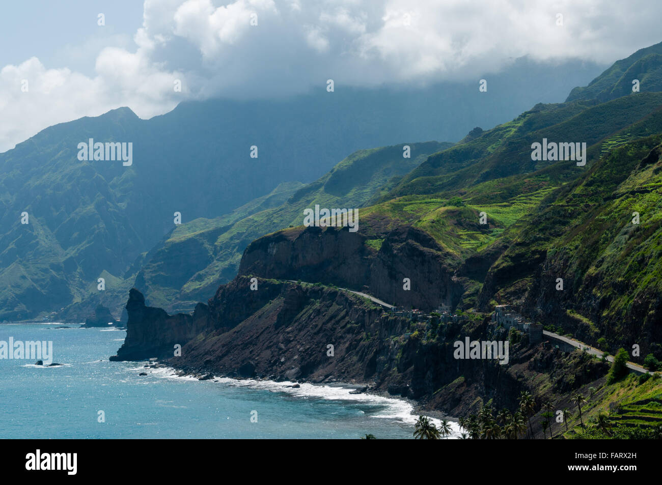 Black coastline road with houses on green cape verde island with high ...