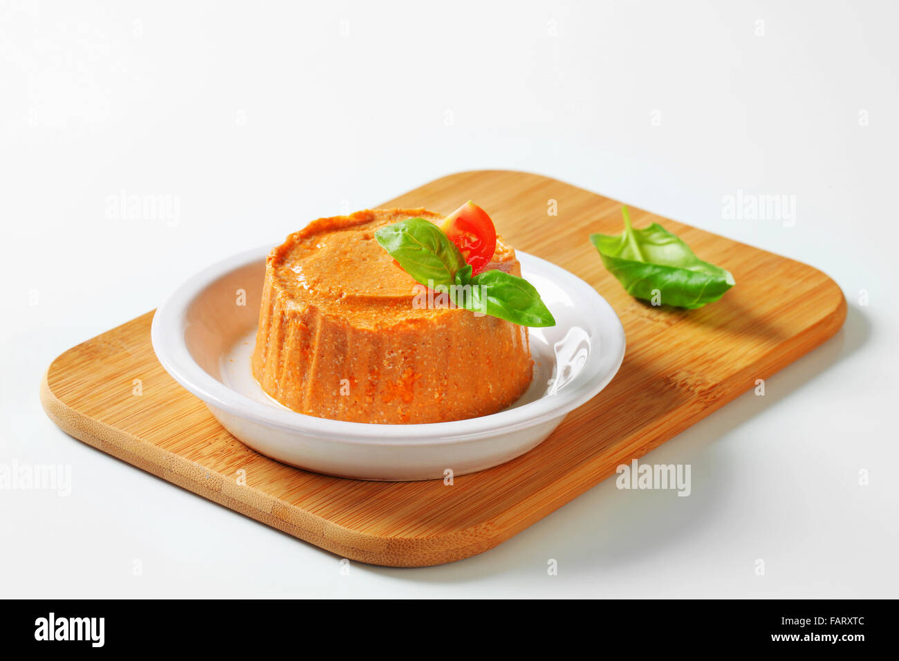 Roasted vegetable chickpea pate on white plate Stock Photo - Alamy