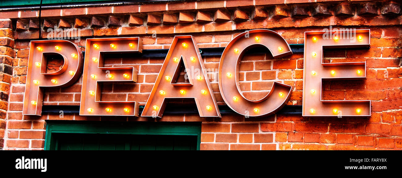 Peace sign on brick wall Stock Photo - Alamy