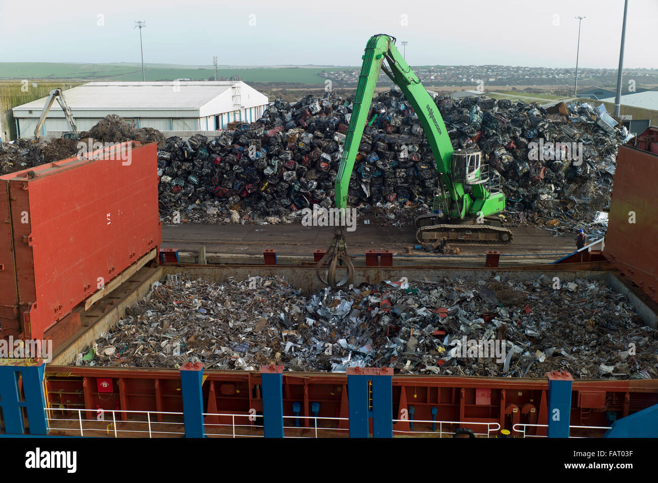 Crane loading scrap metal onto cargo ship, Newhaven, Sussex, UK Stock ...