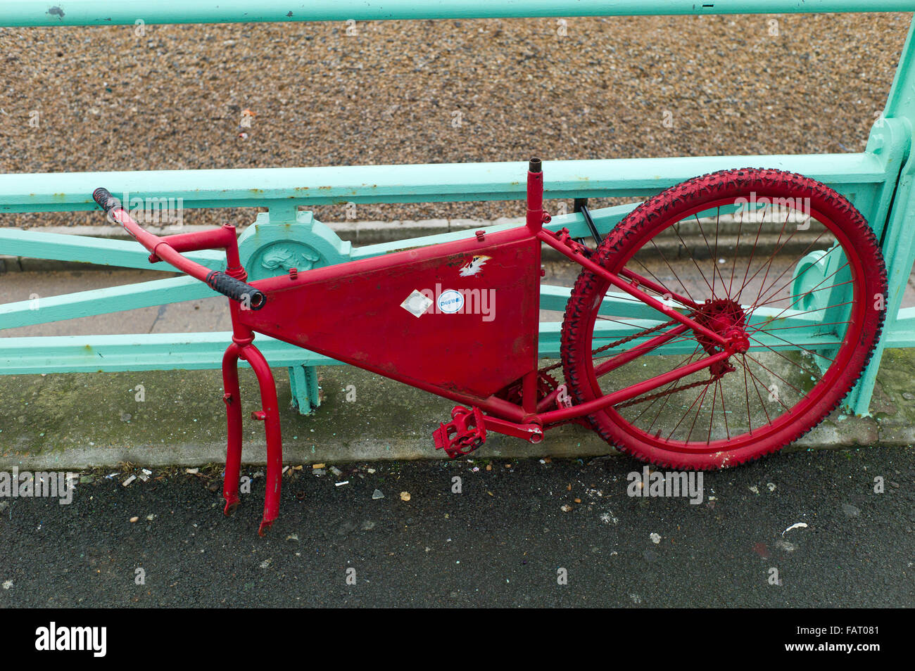 Remains of unusual red bicycle chained to green railings, Brighton, UK ...