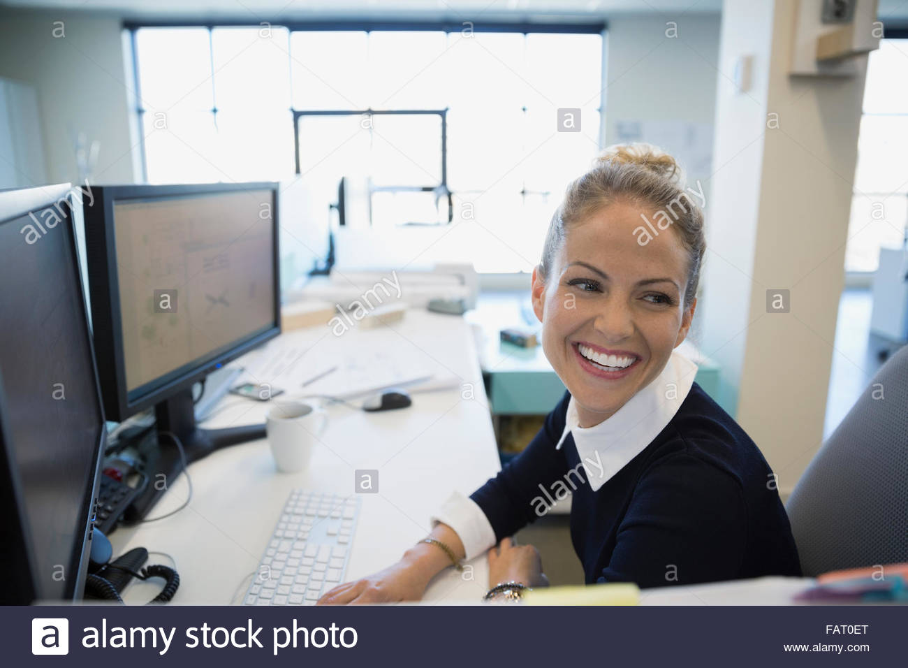 Smiling architect working at computer at office desk Stock Photo - Alamy