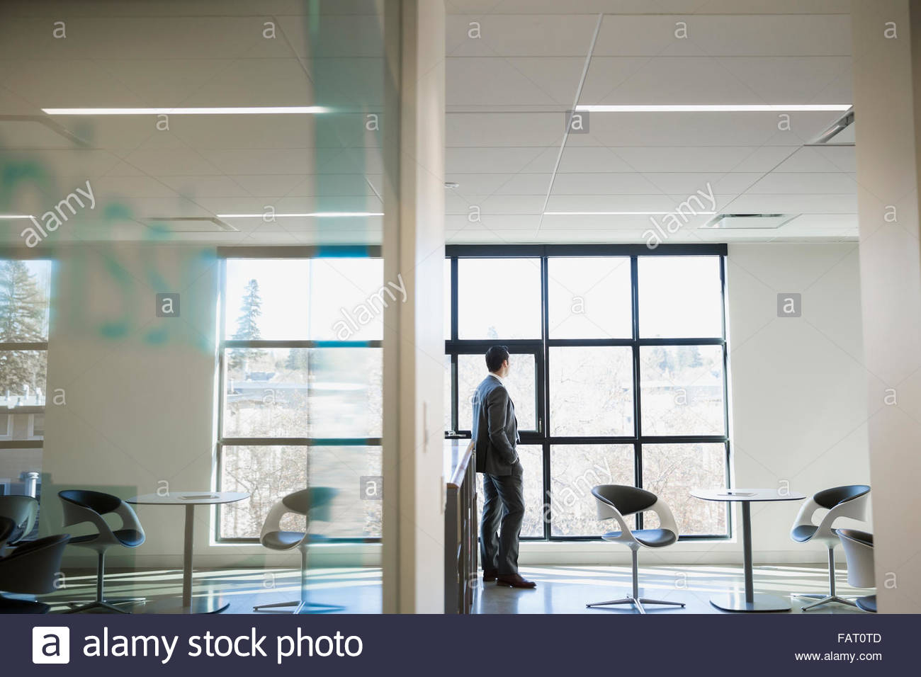 Businessman looking out of the window hi-res stock photography and ...