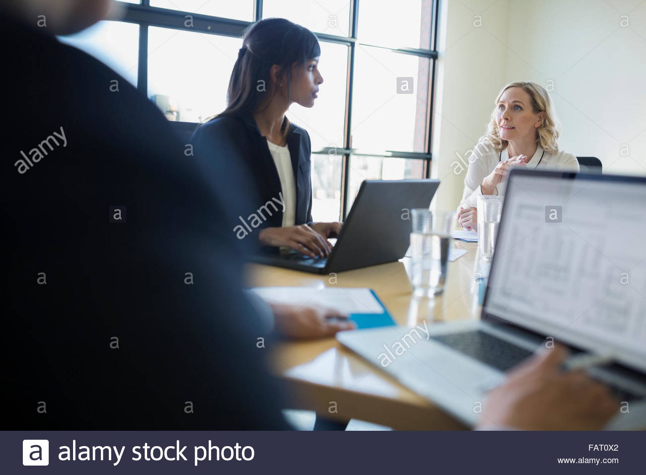 Business people at laptops working conference room meeting Stock Photo ...
