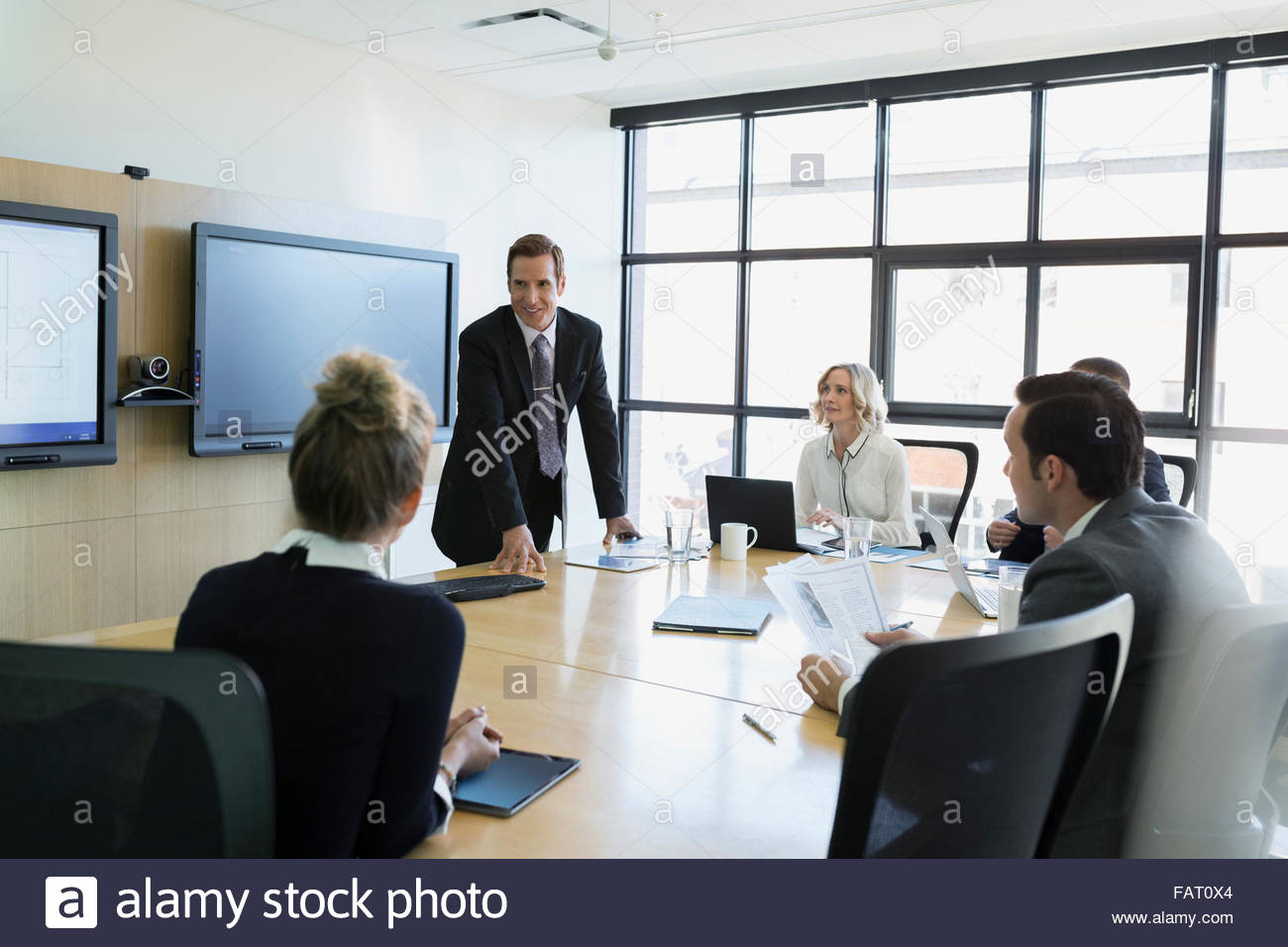 Businessman leading meeting in conference room Stock Photo - Alamy