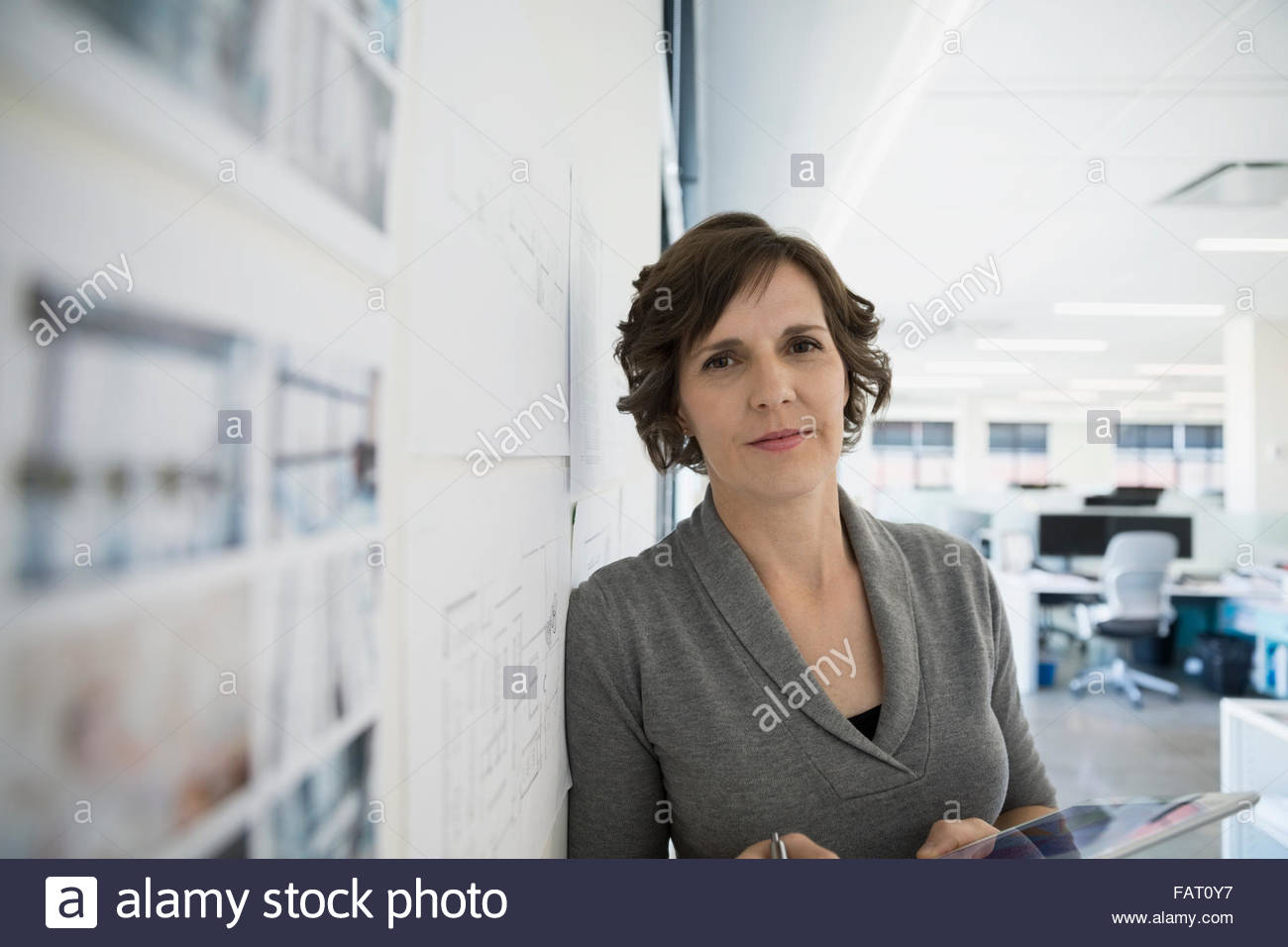 Portrait confident architect leaning on board with blueprints Stock ...