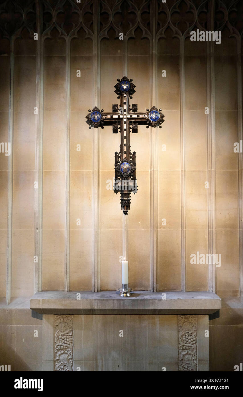 a simple stone alter with cross on wall and candle Stock Photo - Alamy
