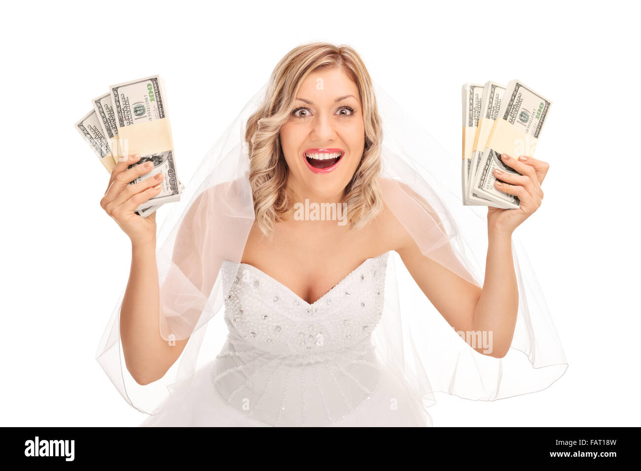 Young bride in a white wedding dress holding few stacks of money ...