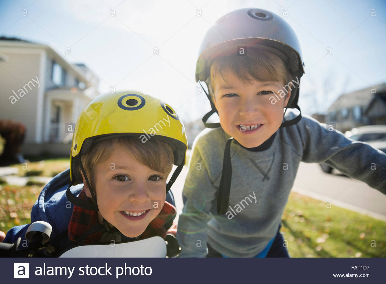 Portrait smiling brothers wearing helmets Stock Photo - Alamy