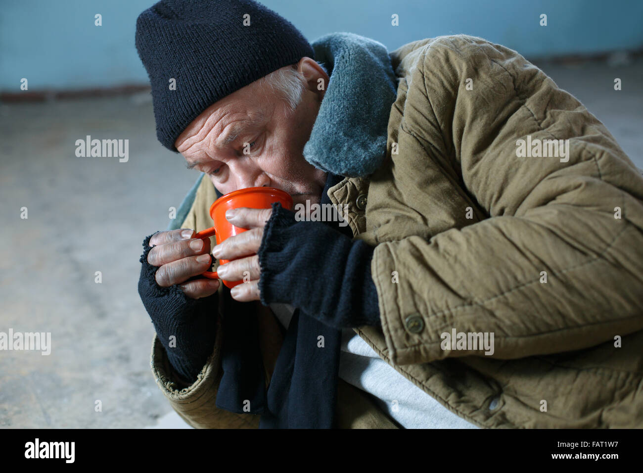 Homeless man hungrily drinking water Stock Photo - Alamy