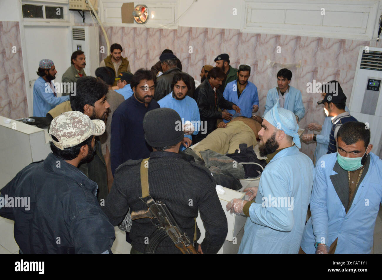 Quetta. 4th Jan, 2016. Doctors examine a body at a hospital in ...