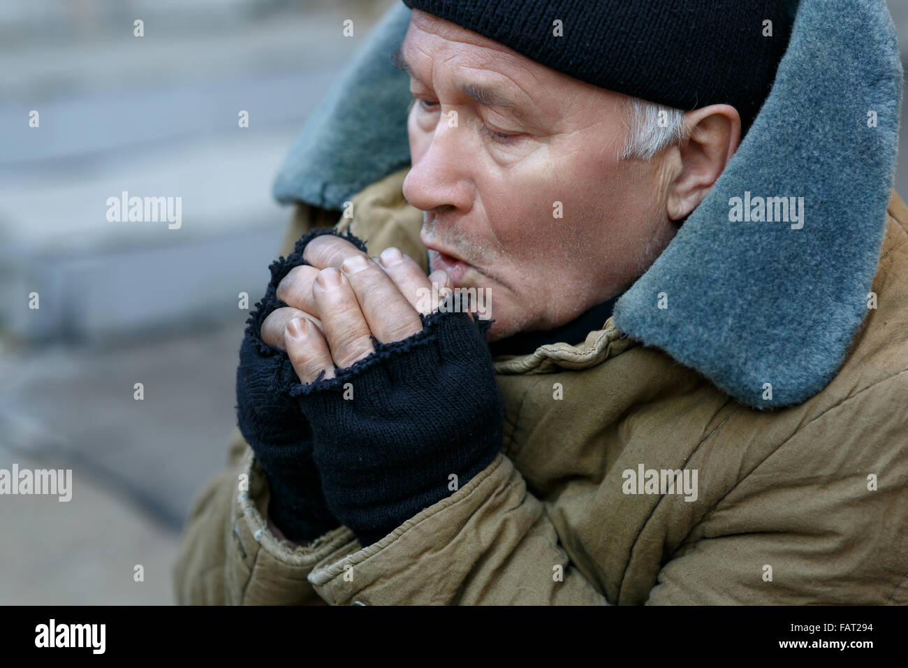 Homeless man is feeling cold Stock Photo - Alamy