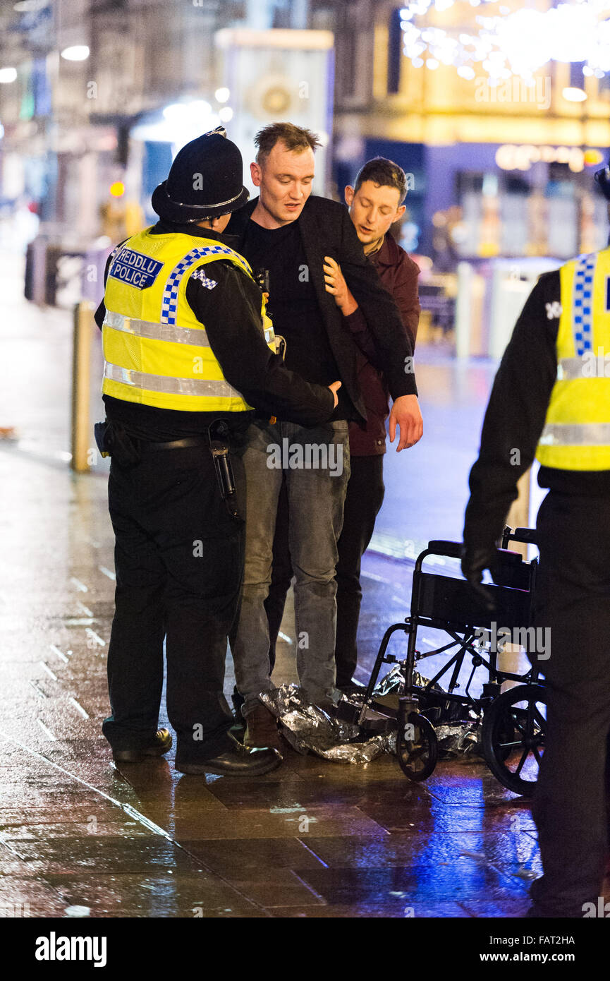 Pictured: Police assist a man who was in need of help and lying on the ...