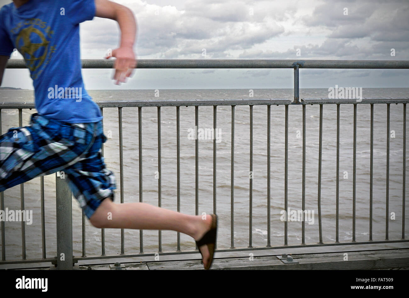 boy running on pier Stock Photo - Alamy