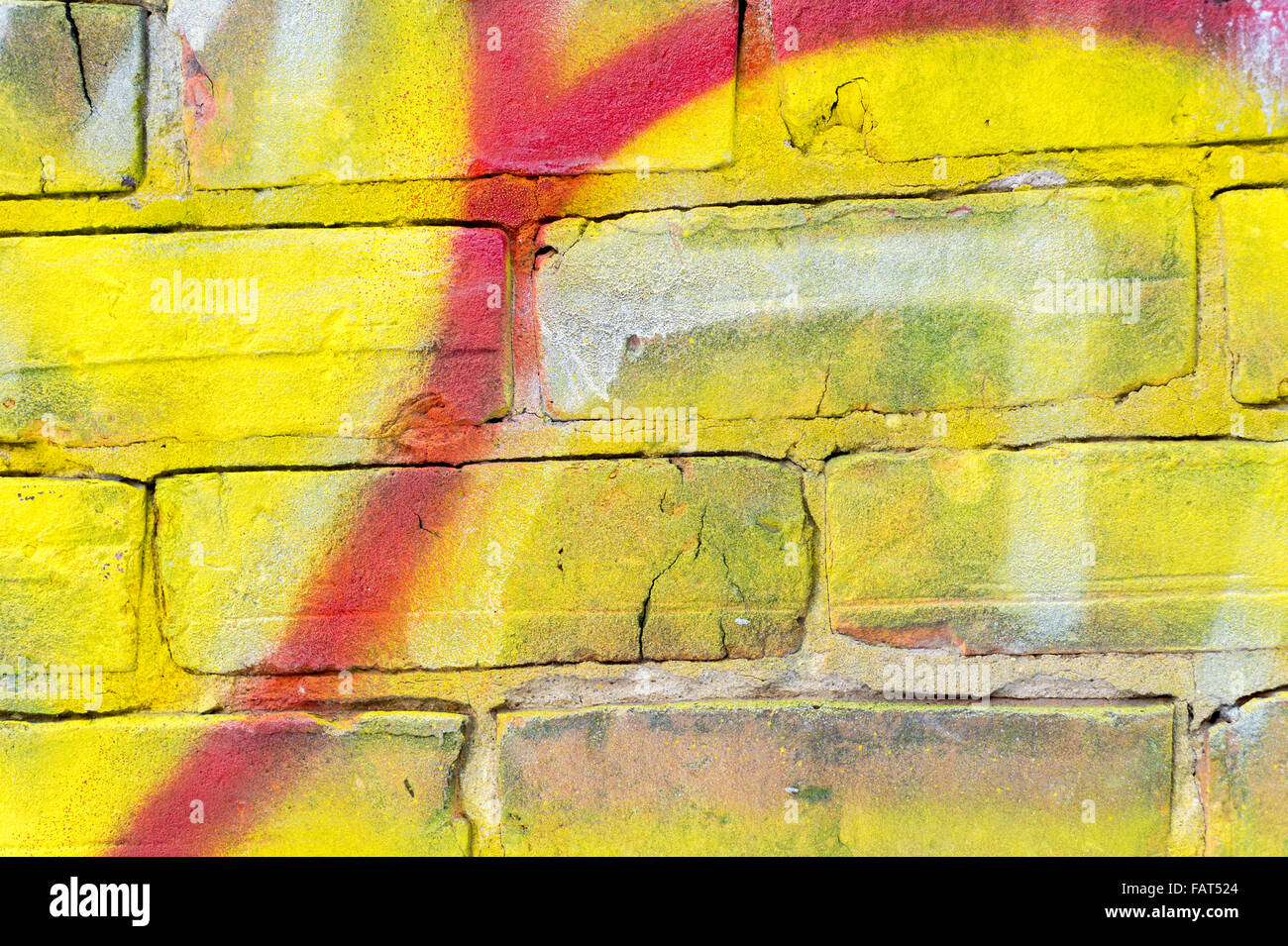 Detail of a red and yellow graffiti on a brick wall Stock Photo - Alamy