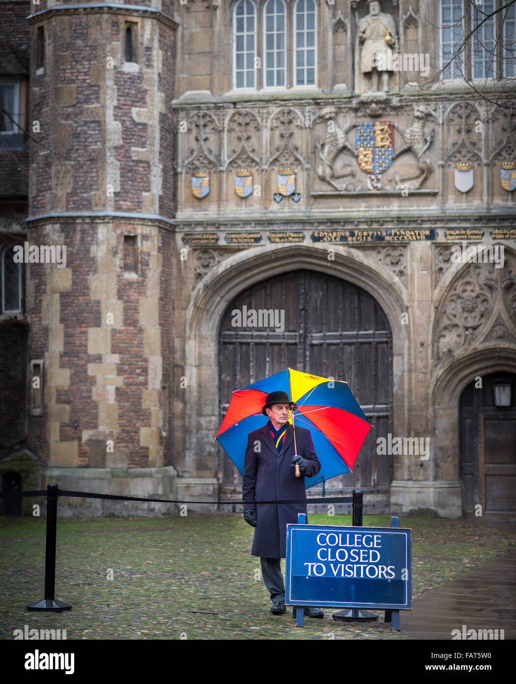Security guard (proctor's officer) stands in the rain on a wet winter ...