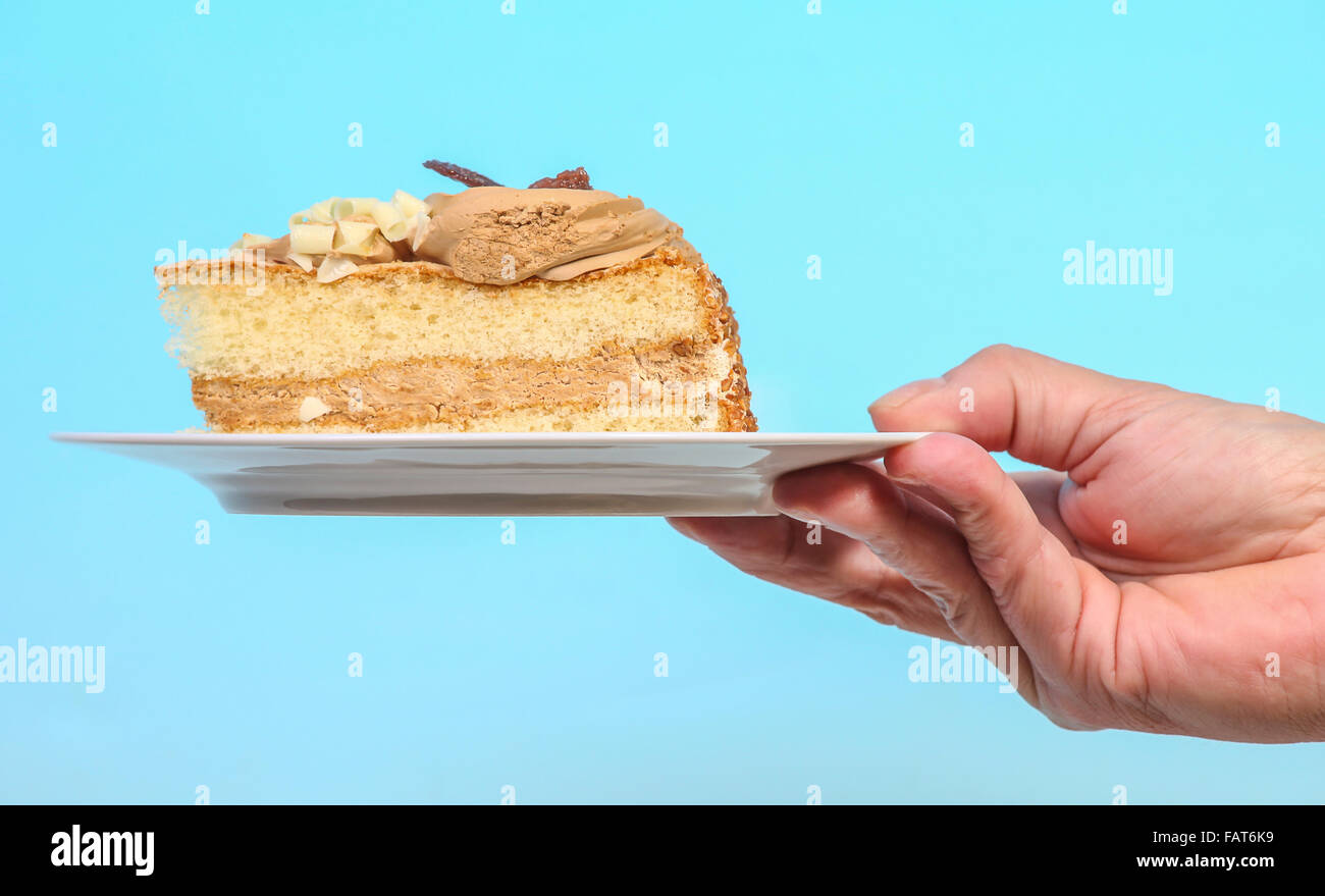 Female hand offering cake on a plate Stock Photo - Alamy