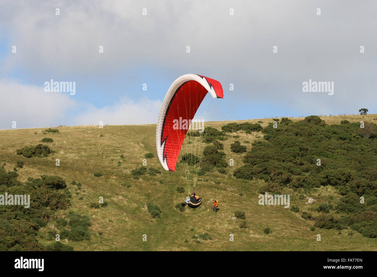 Pilot flying a paraglider against a blue sky perhaps with clouds Stock ...
