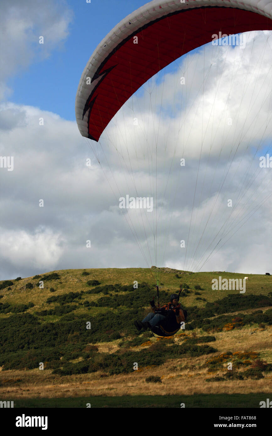 Pilot flying a paraglider against a blue sky perhaps with clouds Stock ...