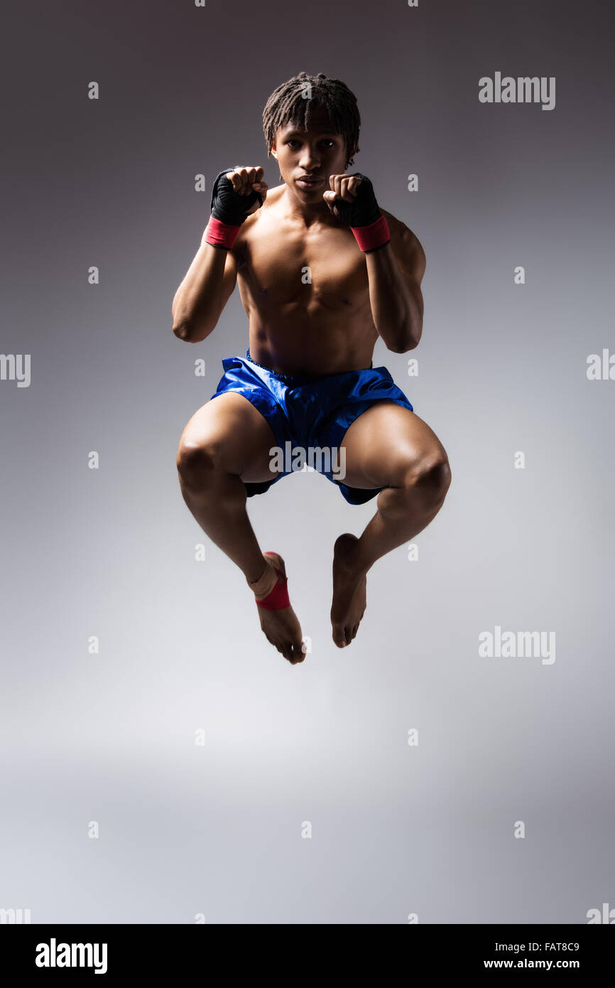 Young muscular athletic male boxer wearing blue boxing shorts and red ...