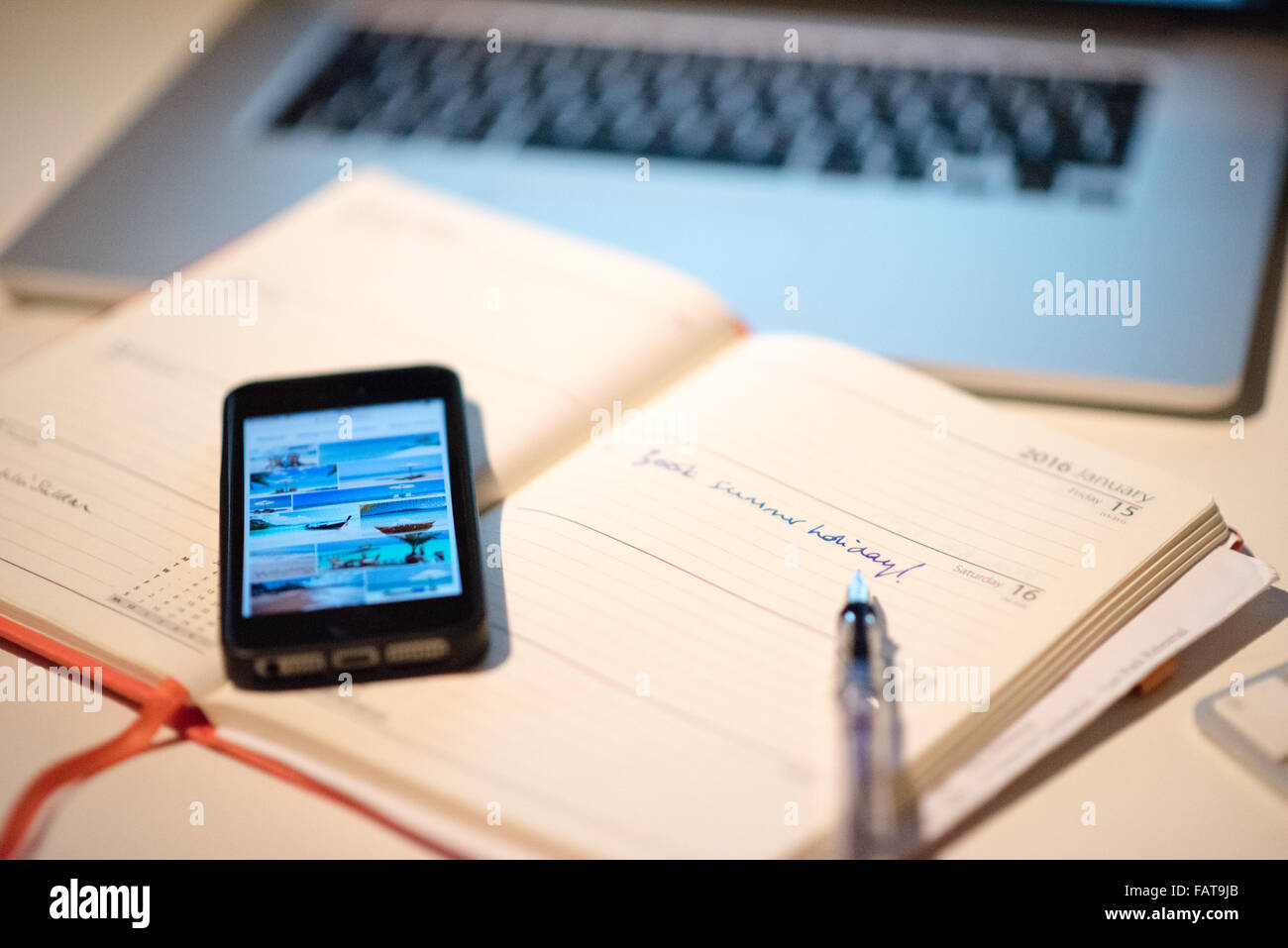 An open diary with the words book summer holiday scribbled on a page ...